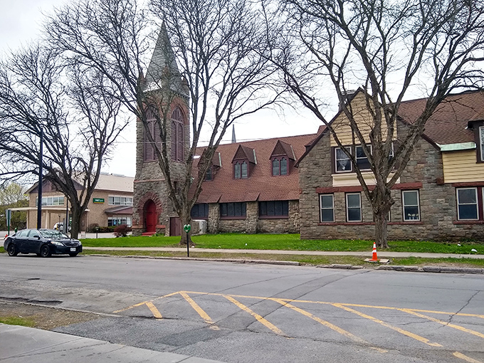 Historic stone church stands proudly in Herkimer, its weathered tower reaching skyward like a small-town sentinel guarding generations of memories.