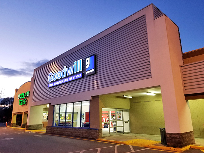 The Horizon Goodwill store glows at dusk, welcoming bargain hunters with its bright blue sign and spacious entrance.