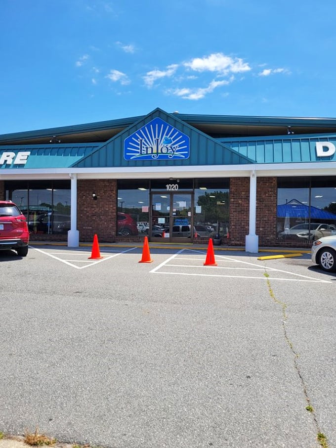 InJoy Thrift Store's blue sunburst logo radiates positivity. Orange traffic cones can't keep dedicated thrifters from their treasure hunt!