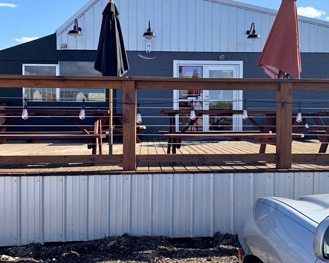 Johnson's blue building stands out like a beacon of BBQ hope. That wooden deck practically begs for sticky fingers and cold drinks.