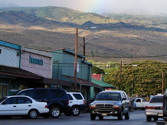 Molokai's main street stretches quietly toward distant mountains, offering peaceful simplicity that expensive resorts can never truly replicate or buy.