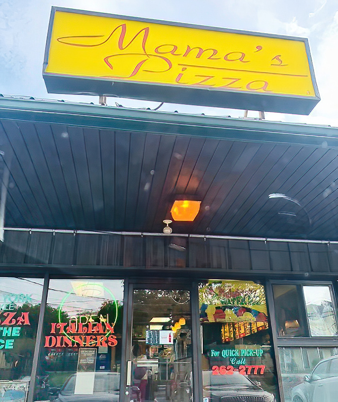 Mama's bright yellow sign cuts through the darkness, a beacon of hope for the pizza-hungry masses.