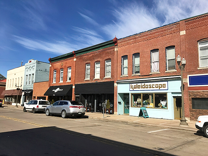 Menomonie's Main Street shines under Wisconsin blue skies, where shops like "Kaleidoscope" add splashes of color to retirement living.