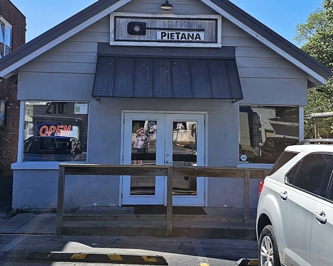 PieTana's humble gray cottage might look unassuming, but inside lies pizza magic worth discovering.