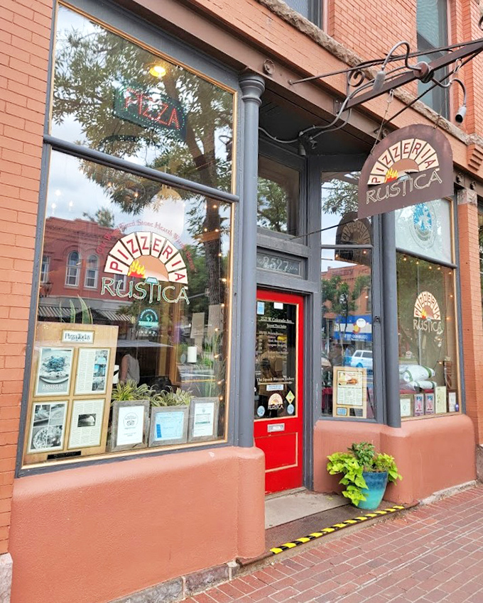 That charming brick storefront with the red door looks like it was plucked straight from a postcard of small-town Italy.