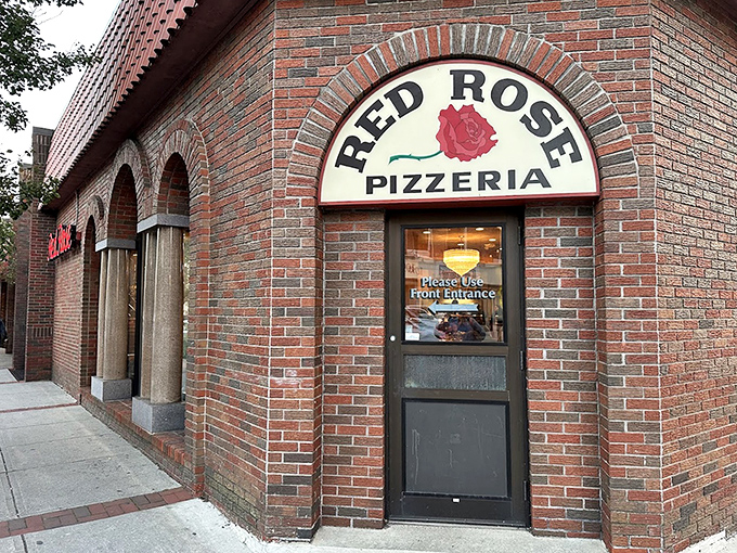 Red Rose Pizzeria: The brick archway and rose sign welcome you like an old friend, promising comfort food that's stood the test of time.
