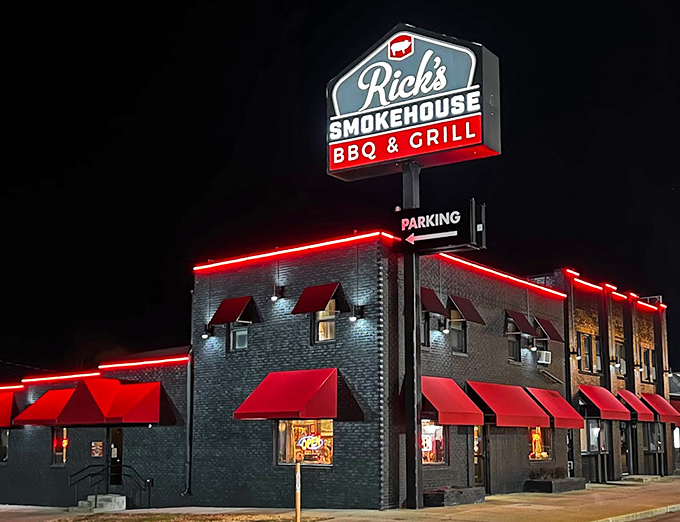 Red neon glows like BBQ coals at night. Rick's Smokehouse beckons hungry souls with promises of smoky delights.