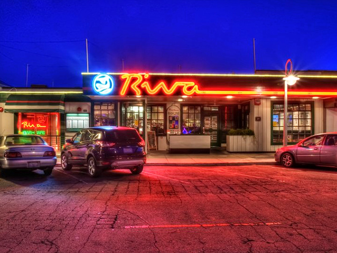 Riva Fish House glows like a neon dream against the night sky&mdash;a beacon for seafood lovers after dark.