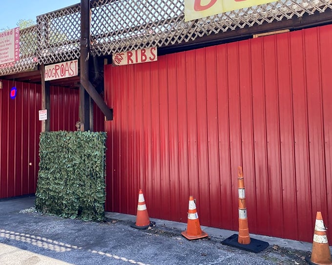 Rollin' Smoke's bright red exterior stands out like a BBQ beacon. Those orange traffic cones might as well say, "Slow down for flavor ahead!"
