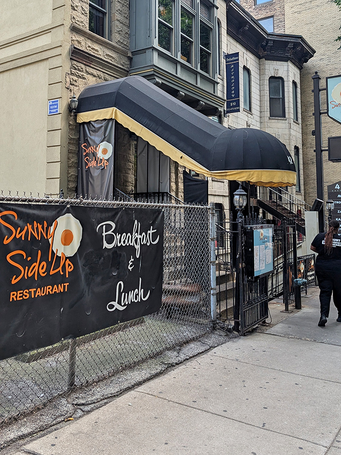 Sunny Side Up's elegant storefront brings a touch of sophistication to breakfast. The black awnings hint at the elevated morning experience waiting inside.