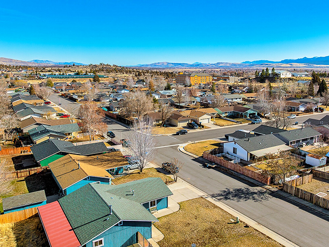 Mountain valley neighborhoods nestle peacefully under pine-covered peaks that make every window a potential postcard.