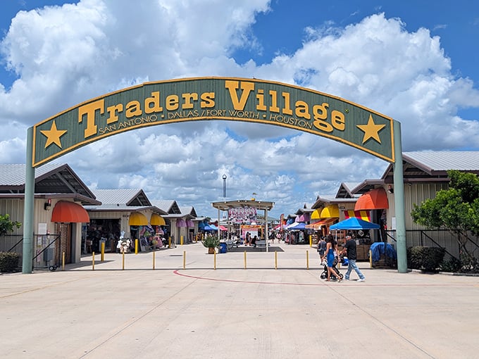 Grand entrance to bargain paradise! Traders Village San Antonio welcomes visitors with its impressive green and gold archway.