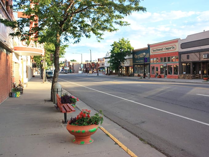 A simple bench and cheerful flowers welcome visitors to Walsenburg's main street, where your retirement dollars bloom too.