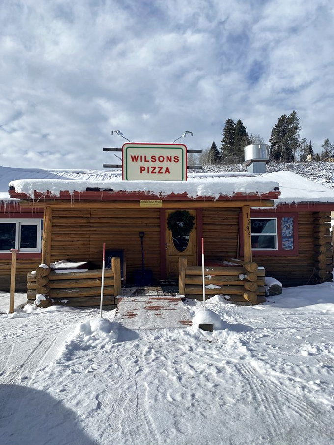 Snow-covered and smoke-scented, this log cabin pizzeria looks like it was plucked straight from a winter wonderland postcard!