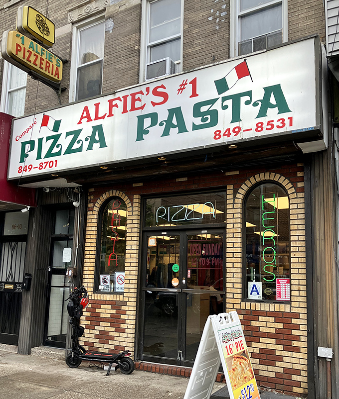 Alfie's Pizzeria: That charming brick-framed entrance is like a portal to pizza paradise - complete with the "OPEN" sign of happiness.