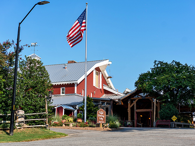 The iconic red barn structure stands proud against Carolina blue skies – a beacon for beef lovers.