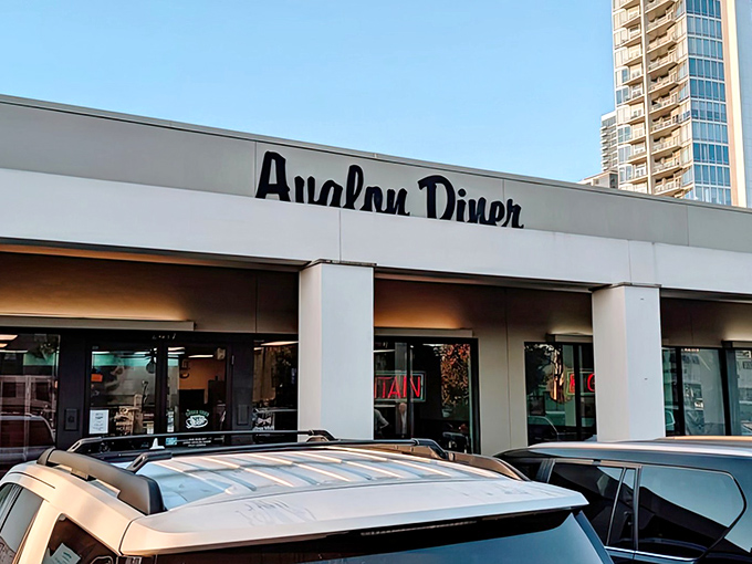 Nestled between city buildings, Avalon Diner keeps Houston's diner tradition alive. That classic sign promises retro delights inside!