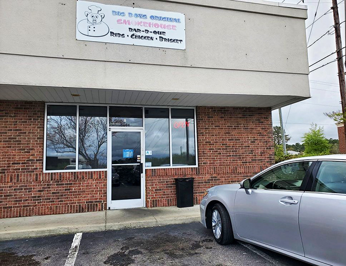That cheerful pig mascot on the sign knows exactly what kind of smoky magic awaits behind these humble brick walls.