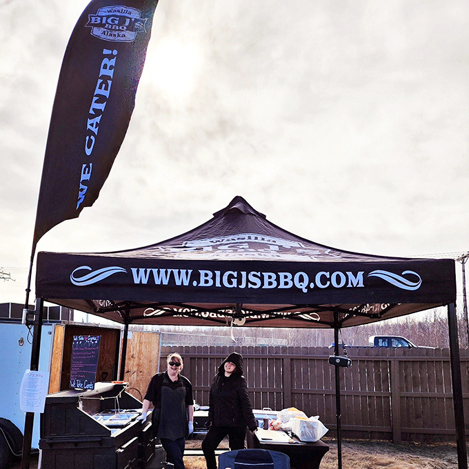 These dedicated BBQ enthusiasts brave all weather to serve their community tender, smoky perfection from their reliable outdoor setup.