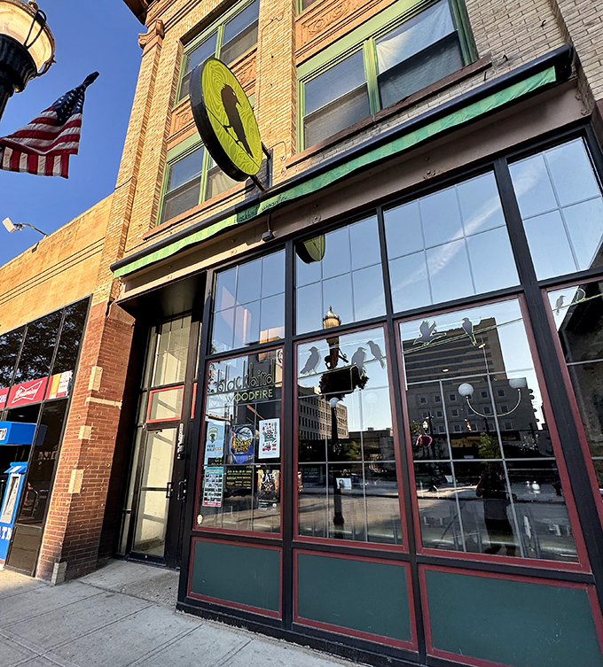 That blue brick exterior stands out like a beacon for pizza lovers seeking authentic wood-fired flavors.