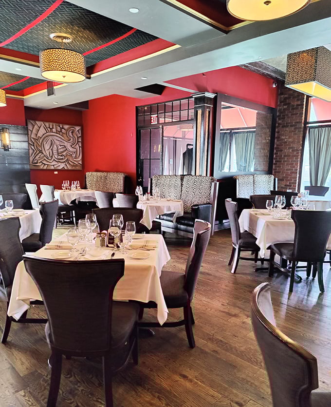 Red walls, white tablecloths, and black chairs create the perfect backdrop for the star of the show&mdash;your perfectly cooked steak.