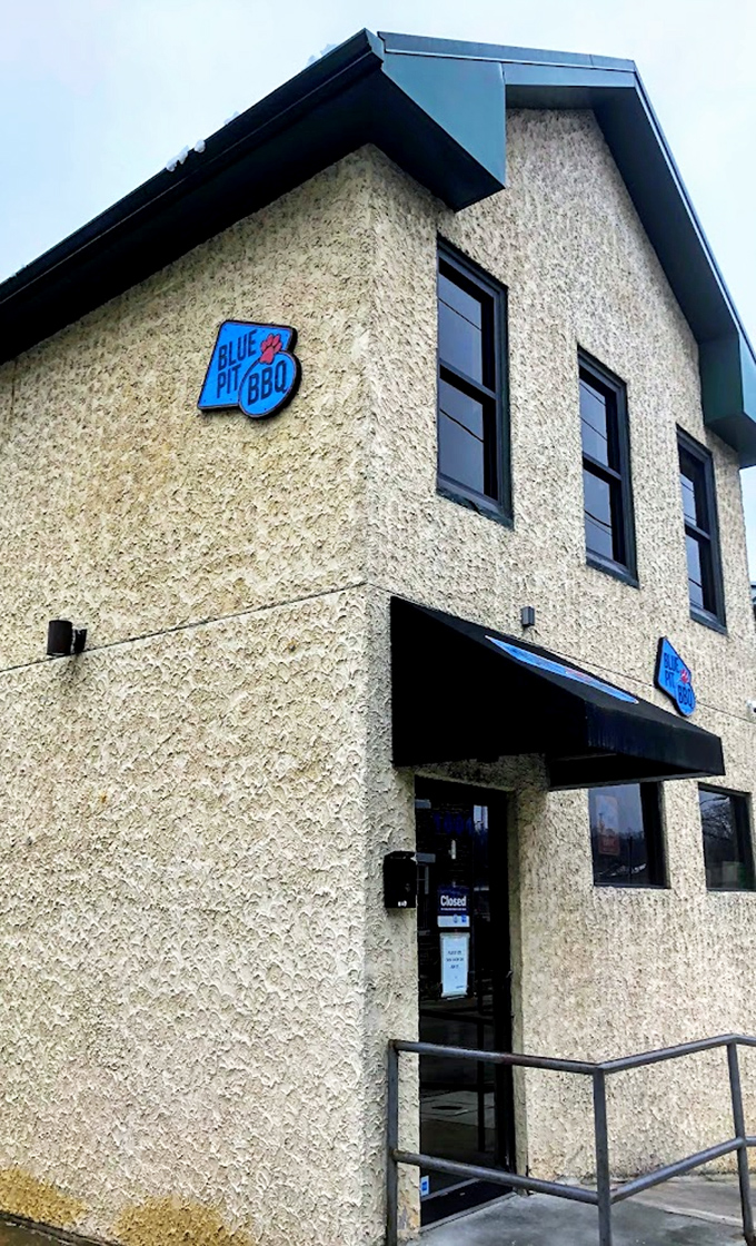 The corner building housing Blue Pit BBQ looks unassuming, but that blue sign marks the spot where whiskey meets smoke in perfect harmony.