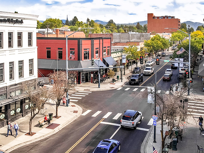 The heart of downtown Coeur d'Alene offers tree-lined streets where shoppers pause to appreciate mountain views between purchases.