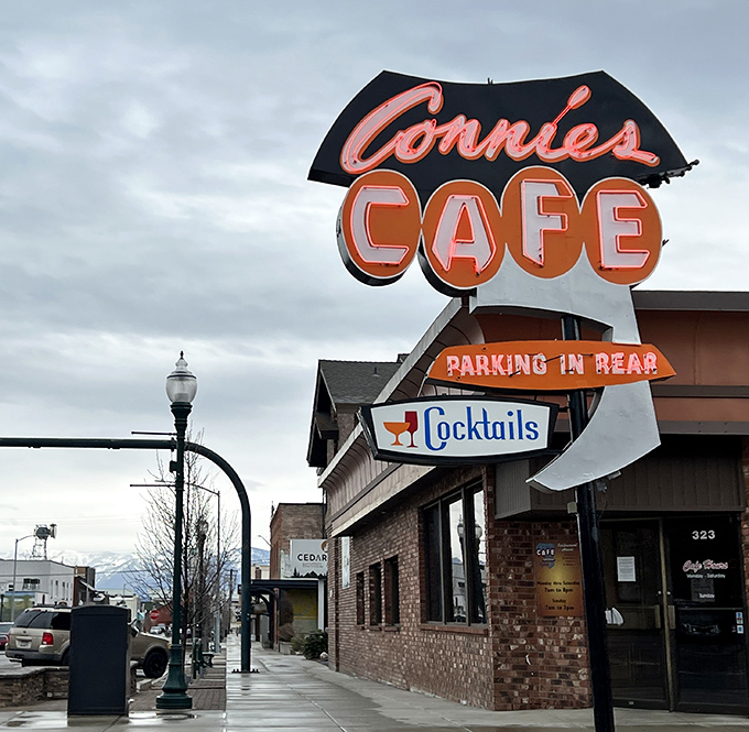 Rain or shine, Connie's vintage sign welcomes hungry locals. That "Parking in Rear" notice has guided three generations of diners.