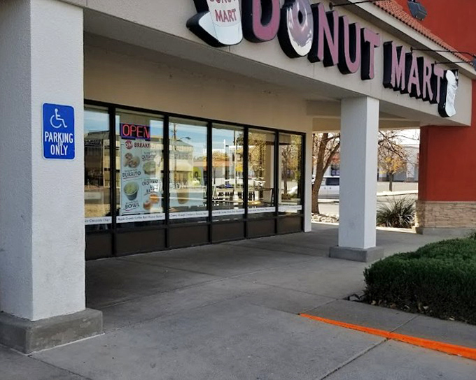 The accessible entrance isn't the only welcoming thing about Donut Mart—those windows practically whisper "come get your sugar fix" to passersby.
