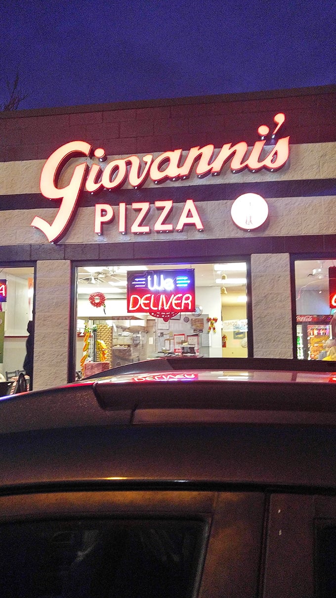 Giovanni's glowing sign cuts through the night like a lighthouse for the pizza-starved soul. The "We Deliver" might be poetry.
