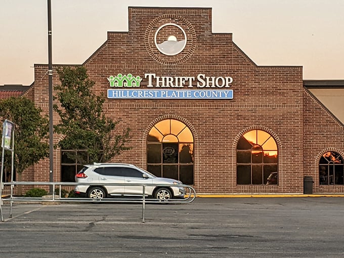 As the sun sets, Hillcrest Thrift Shop glows with promise&mdash;tomorrow's treasures waiting behind those elegant arched windows.