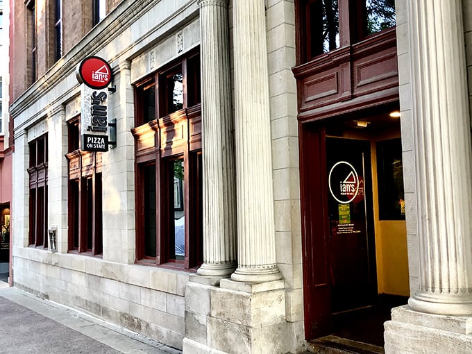 Classic columns frame the entrance to Ian's pizza paradise. College students' late-night salvation awaits inside!