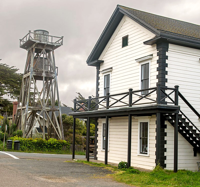 Historic lighthouse and keeper's quarters stand sentinel on the foggy coast&mdash;a reminder of when these beacons were lifelines, not just photo ops.