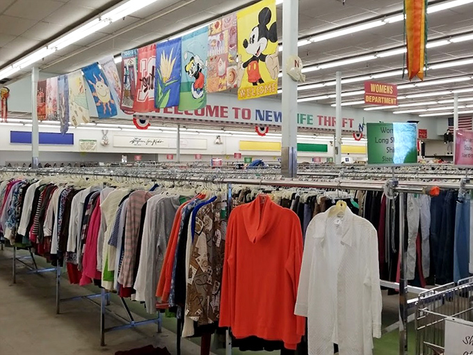 Rows of clothing stretch toward cartoon characters on the wall. It's like Disney characters are cheering on your bargain hunting adventures!