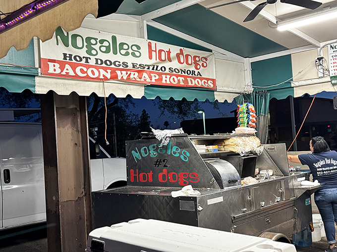 The handwritten sign promises "Bacon Wrap Hot Dogs"&mdash;three words that create a perfect Sonoran street food symphony.