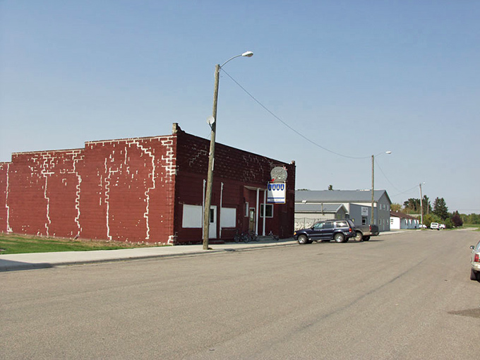 The faded paint on Pembina's vintage buildings tells stories of bygone eras. Small-town patina at its most authentic.