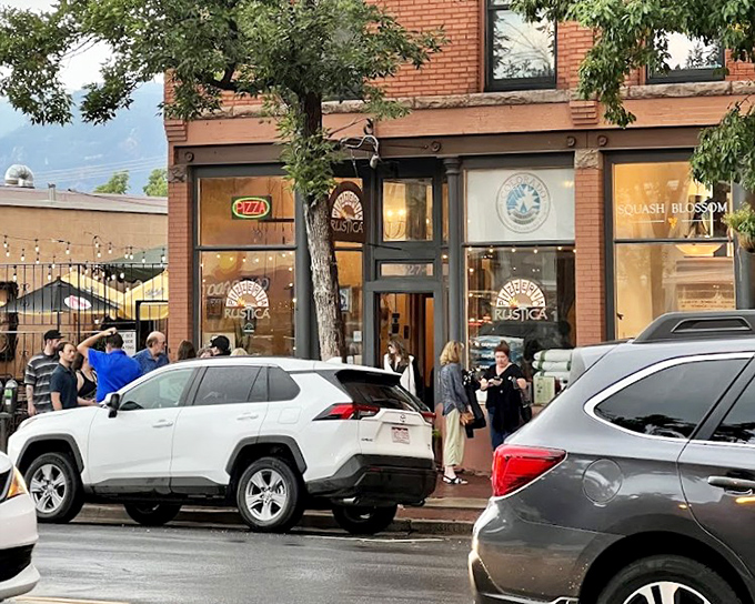 Pizzeria Rustica's inviting entrance promises authentic wood-fired magic within those historic brick walls.