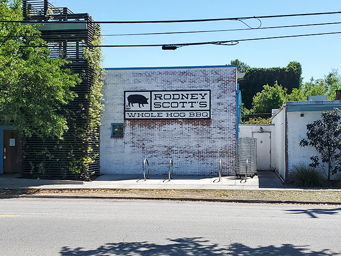 The clean lines of Rodney Scott's exterior belie the complex flavors within. Like finding Shakespeare in a paperback - don't judge this barbecue by its cover.