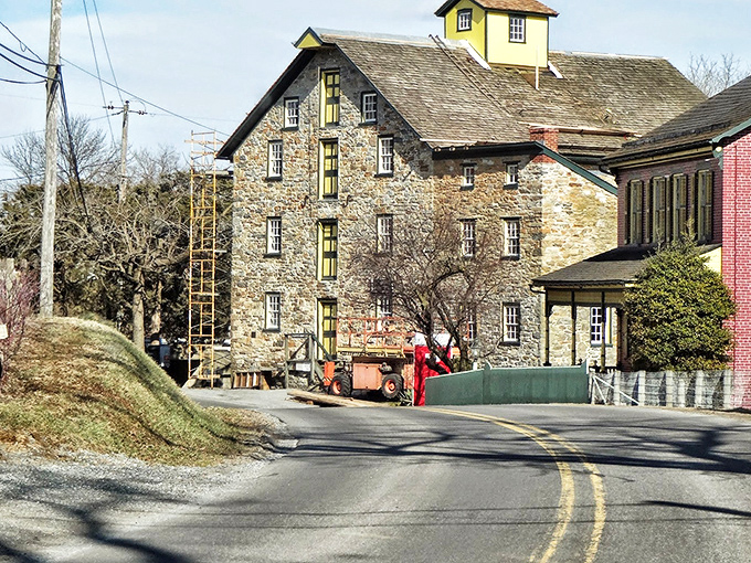 Now here’s a scene straight out of a storybook—an old stone mill standing proud as the road gently curves around it, whispering tales of simpler days.