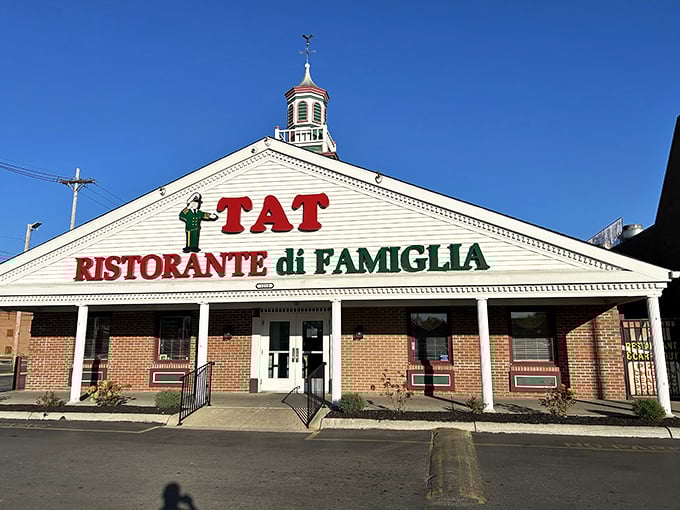 The triangular roofline and warm brick create the perfect backdrop for generations of family pizza nights together.