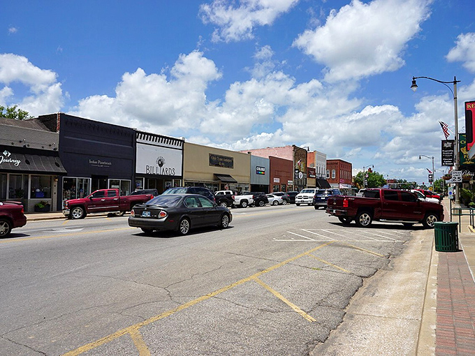 Tahlequah's charming streetscape features a mix of architectural styles, where pickup trucks cruise past storefronts under cotton-candy clouds.