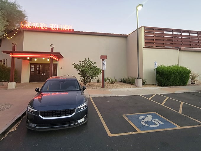 Modern meets traditional at The Stockyards' entrance. The neon sign glows like a beacon for serious steak enthusiasts.