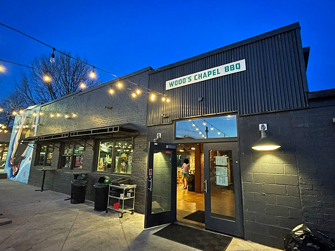 As dusk falls, Wood's Chapel transforms &ndash; string lights creating the perfect atmosphere for enjoying craft BBQ in Atlanta's Summerhill neighborhood.