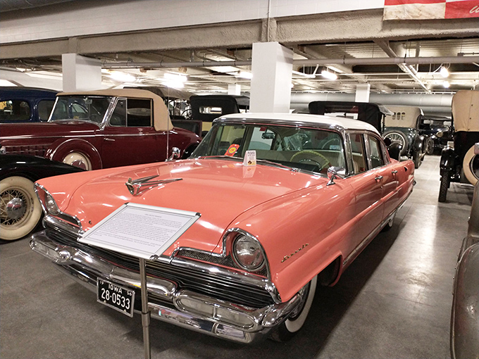 The 1956 Lincoln Premiere in coral pink isn't subtle&mdash;it's automotive jewelry from an era when cars had personalities bigger than Texas.