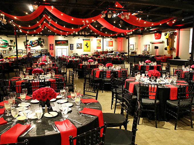The museum transforms for special events, with Ferrari-red tablecloths naturally. Even the chandeliers seem to be admiring the cars below.