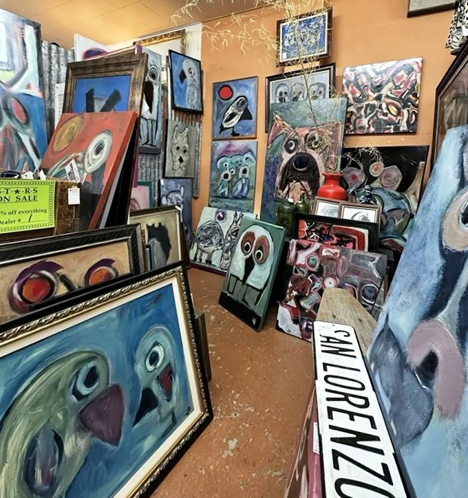 An art corner where paintings stare back at you with the same bewilderment you're feeling. That blue dog definitely knows something.