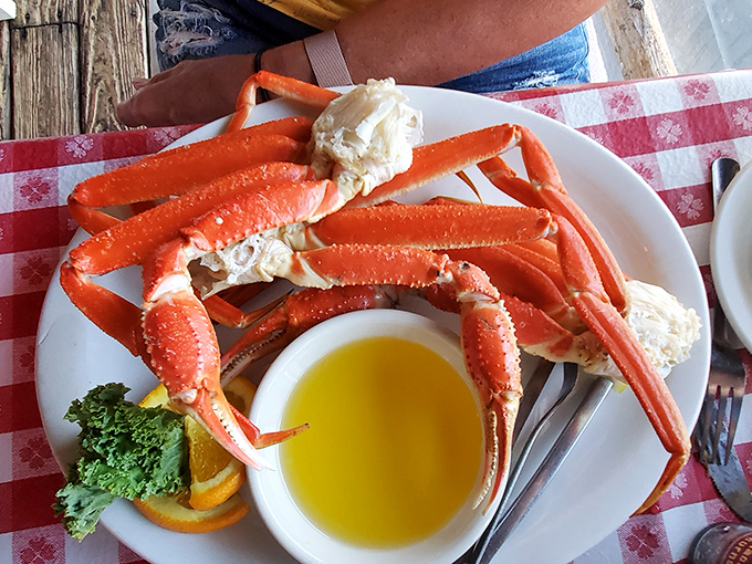 Those aren't just crab legs – they're a maritime masterpiece served on classic checkered tablecloths. Melted butter standing by for the inevitable delicious dunk.