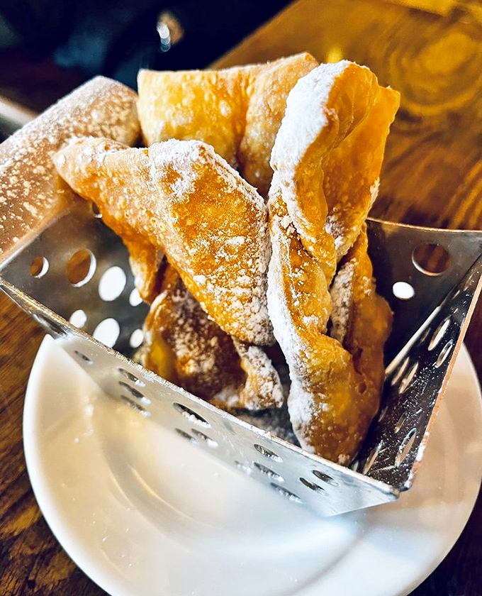 "Angel Wings" indeed—these golden, powdered sugar-dusted pastries are what donut holes dream of becoming when they grow up.
