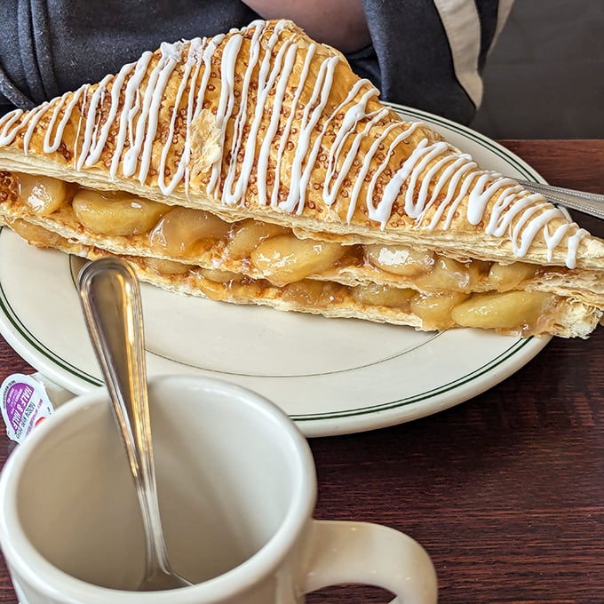This apple turnover isn't just dessert &ndash; it's a flaky, buttery architectural achievement drizzled with icing that would make even the most disciplined dieter weak at the knees.