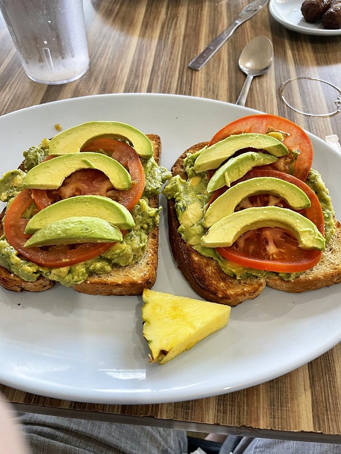 Avocado toast that's practically posing for Instagram&mdash;layers of creamy green goodness and ripe tomatoes that California would approve of.